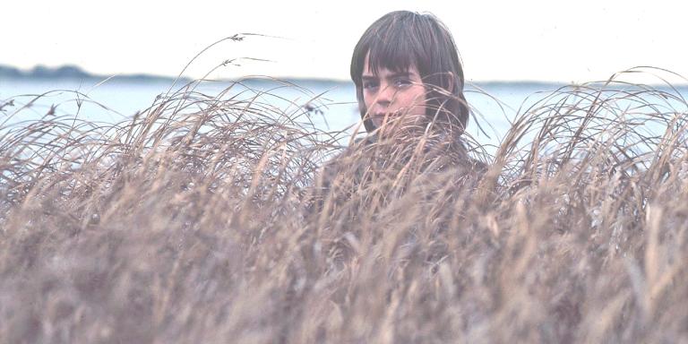 Greg Rowe through long grass | National Film and Sound Archive of Australia