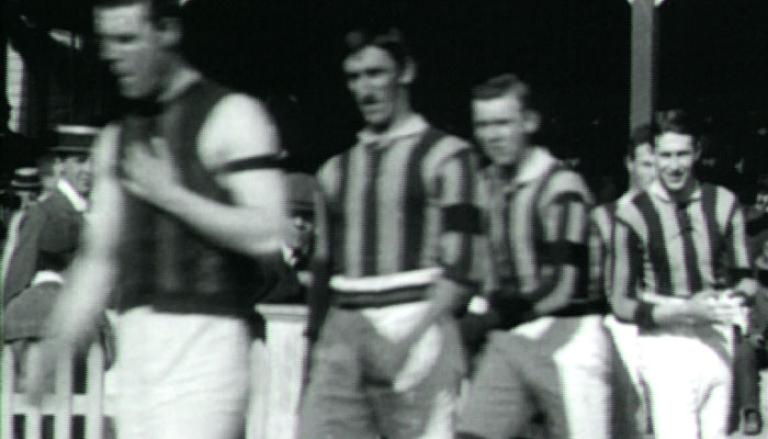 Cananore players with black arm bands walk onto the TCA Ground, Hobart ...