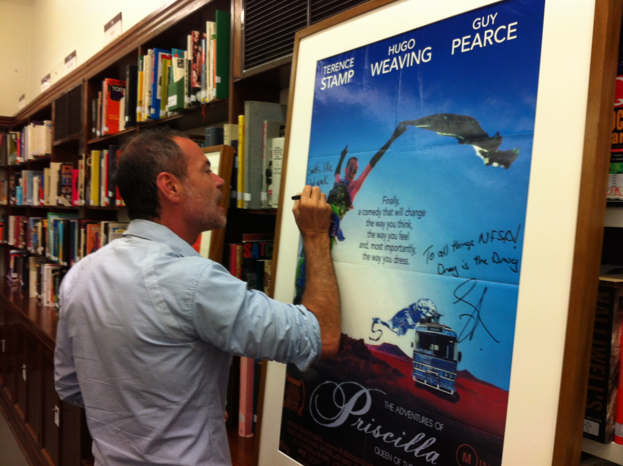 Tim Chappel signing a poster | NFSA Tim Chappel signing a poster | NFSA